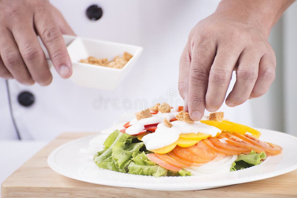 Chief Sprinkle Biscuits on Salad Stock Image - Image of cook, preparing ...