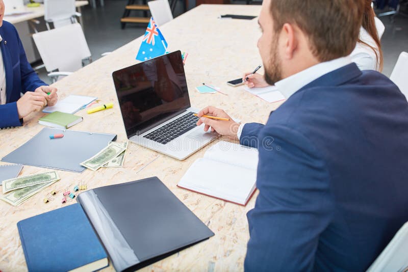 A Chief at the Working Table Intermingles with Office Workers Sitting ...