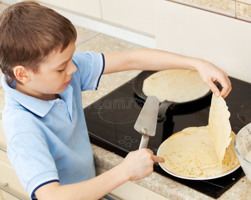 Boy cooking pancakes stock photo. Image of child, white - 28712468
