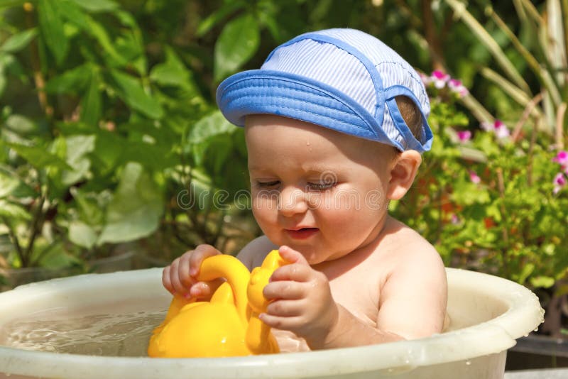 Child is bathed in a basin stock image. Image of face - 43899147