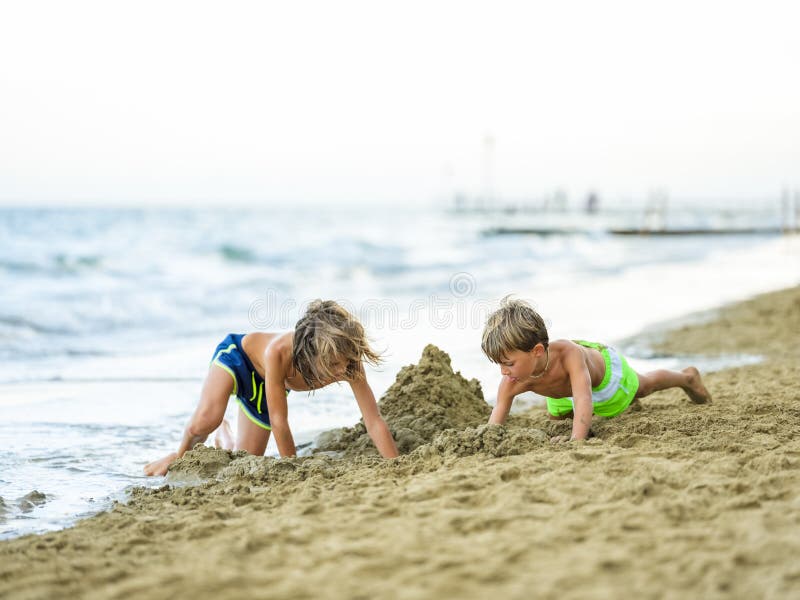 Child in a Bathing Suit Plays on the Sand at the Beach on a Sunny Day ...