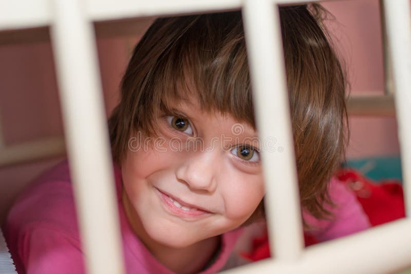 Child Behind Bars of the Crib Stock Image - Image of happy, horizontal ...