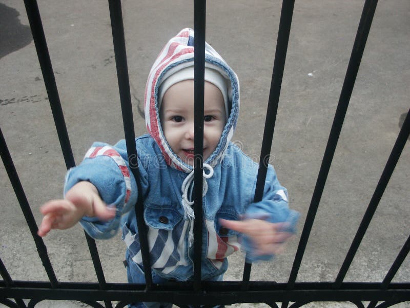Child behind gate stock photo. Image of face, childhood - 2058956