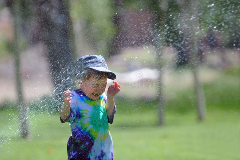 Child Being Sprayed by Water Stock Photo - Image of excited, enjoys ...