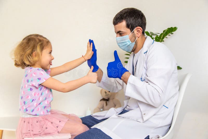 A Child is Being Treated by a Doctor in a Clinic. Selective Focus Stock ...