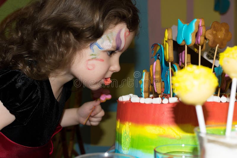 Child bite a rainbow cake stock image. Image of child - 112670739