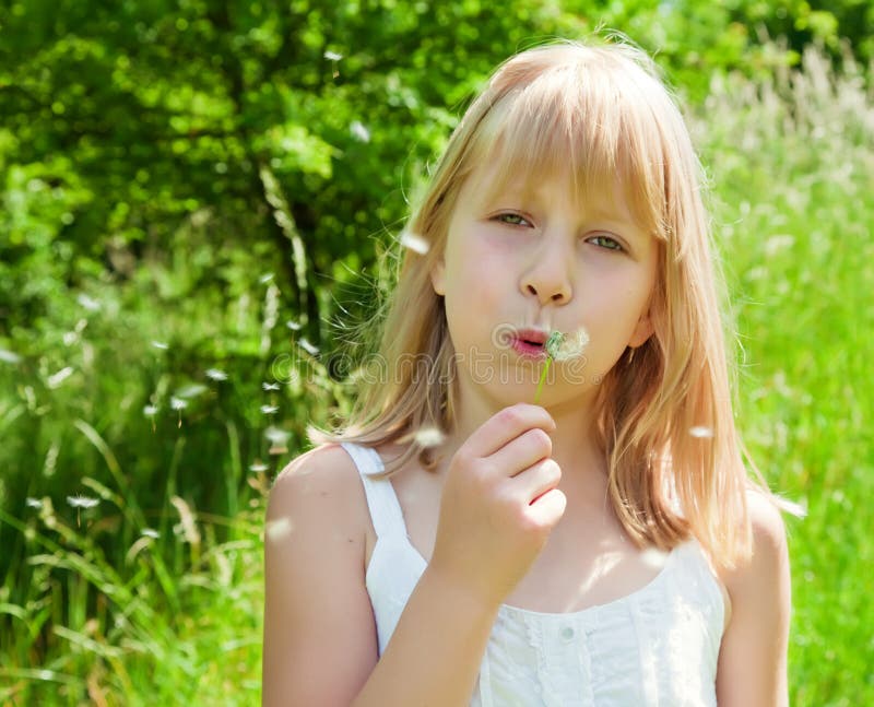 Child Blowing on a Dandelion Stock Photo - Image of meadow, cute: 55660964