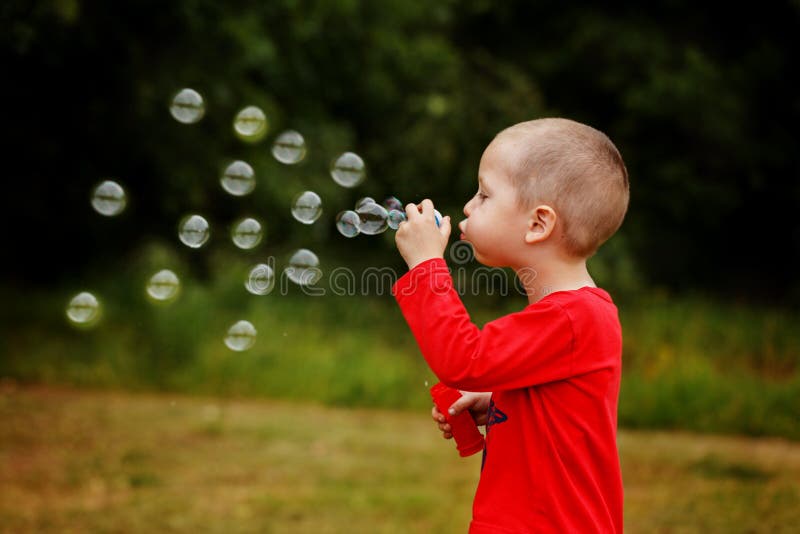Child Blowing a Soap Bubbles. Kid Blowing Bubbles on Nature. Stock ... Child Blowing a Soap Bubbles. Kid Blowing Bubbles on Nature. Stock ...