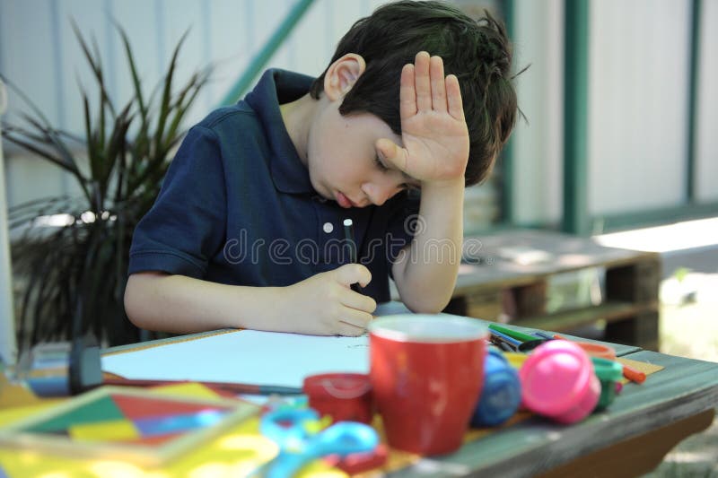 Child Boy Does His Homework at the Backyard and Showing Do Not Disturb ...