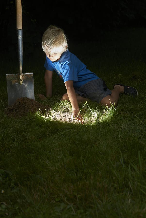 Child Boy Have Unearthed a Treasure in the Grass Stock Photo - Image of ...