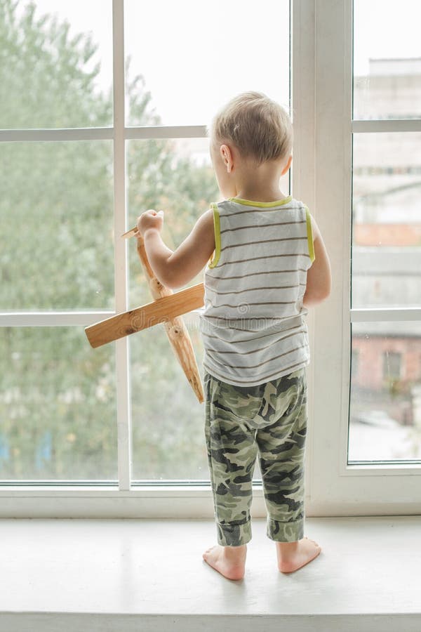 Boy looking out of window stock image. Image of kids, handsome - 3695869