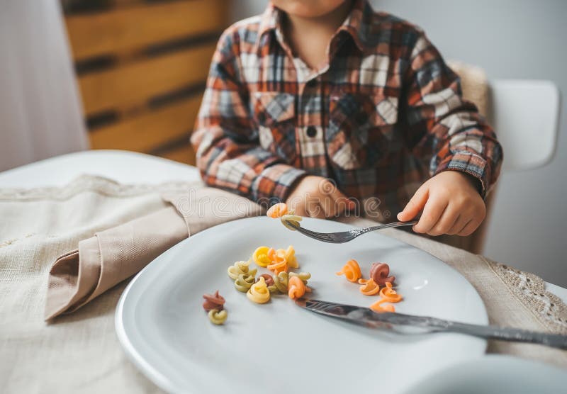Child Boy with Plate of Tasty Paste in Kitchen. Closeup Stock Photo ...