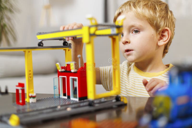 Child Boy Playing and Building with Colorful Plastic Bricks at the ...
