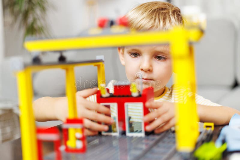 Child Boy Playing and Building with Colorful Plastic Bricks at the ...