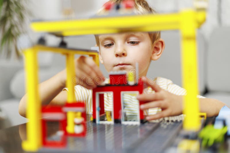 Child Boy Playing and Building with Colorful Plastic Bricks at the ...