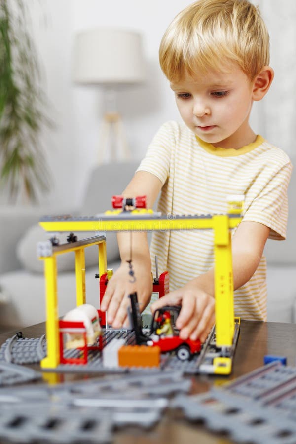 Child Boy Playing and Building with Colorful Plastic Bricks at the ...