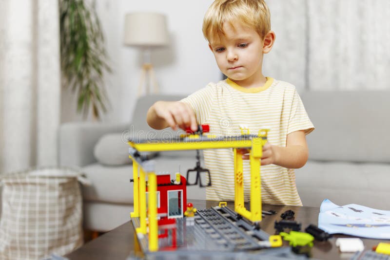 Child Boy Playing and Building with Colorful Plastic Bricks at the ...
