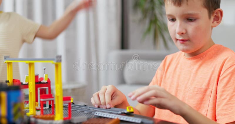 Child Boy Playing and Building with Colorful Plastic Bricks at the ...