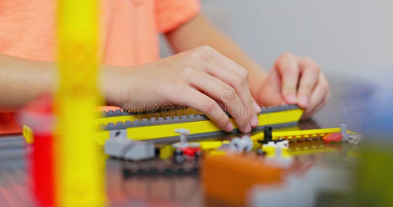 Child Boy Playing and Building with Colorful Plastic Bricks at the ...