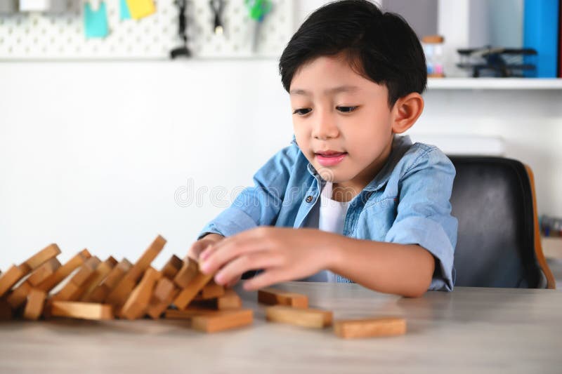Child Boy Playing Jenga Game Exciting at Home. Feeling Fun and Learning ...