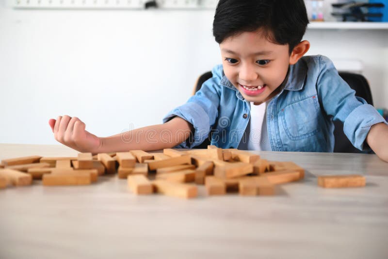 Child Boy Playing Jenga Game Exciting at Home. Feeling Fun and Learning ...