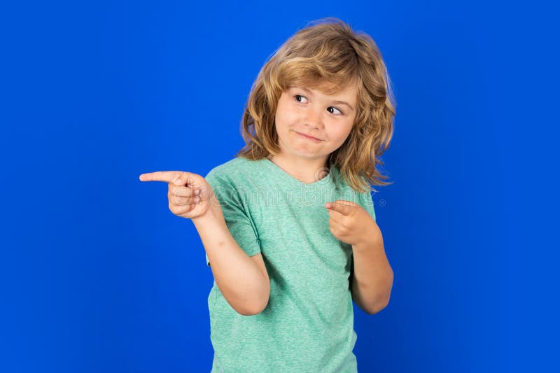 Kid Boy Pointing Away on Blue Isolated Studio Background. Kid with ...