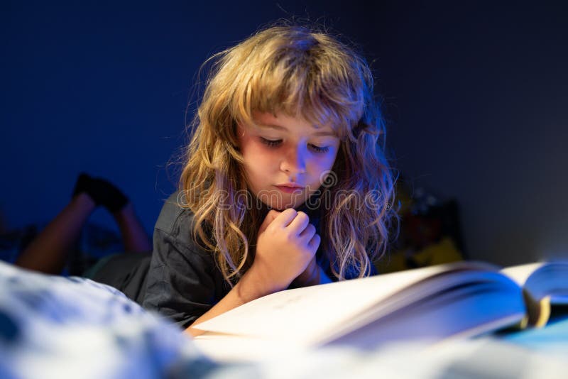 Child Boy Reading Book. Kids Reading Story. Kids Face with Night Light ...