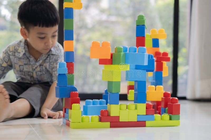 Child Boy Sitting on the Floor in Play Room with Color Block and Play ...