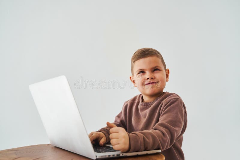 Child Boy Study Online with Laptop and Smiles. Online Education and E ...