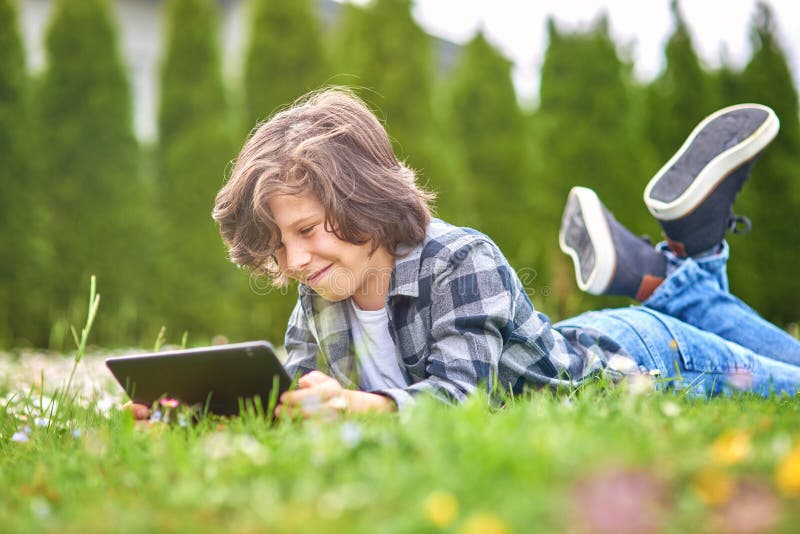 Child Boy Using Digital Tablet in Park Stock Image - Image of game ...