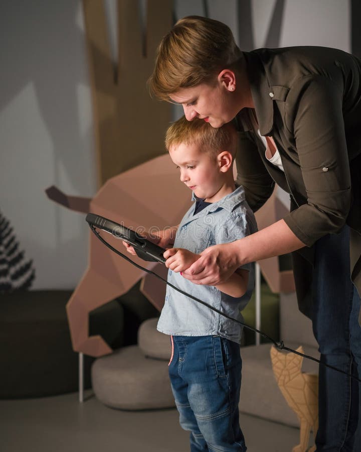 Mother and Her Two Little Children Playing Games in a Museum Playroom Stock Image - Image of ...