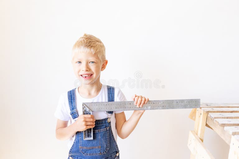 Child Builder Measures a White Wall with a Construction Ruler, Space ...