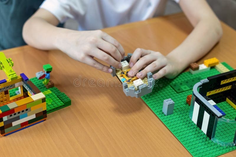 Child Building Creative Brick Structures on Table. Close Up of a Childs ...