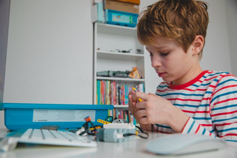 Child Building and Programming Robot on Computer Stock Image - Image of ...