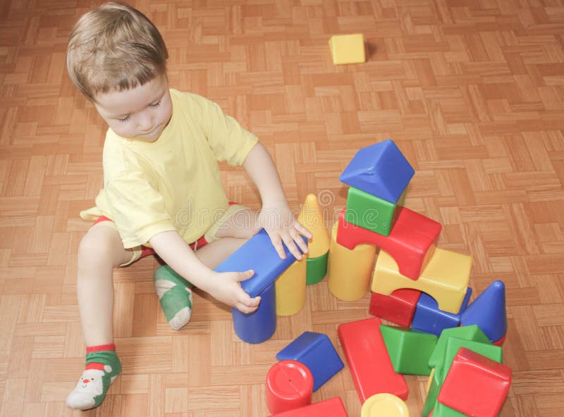 The Child Builds a Castle Out of Plastic Designer. a Little Boy Stock ...