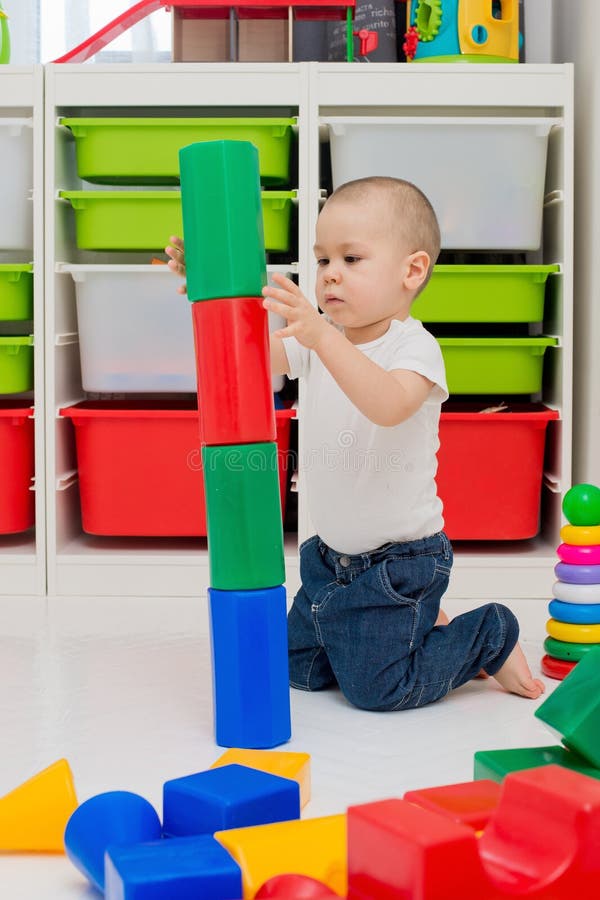 Child Builds a Tower of Cubes Stock Image - Image of activity, puzzle ...