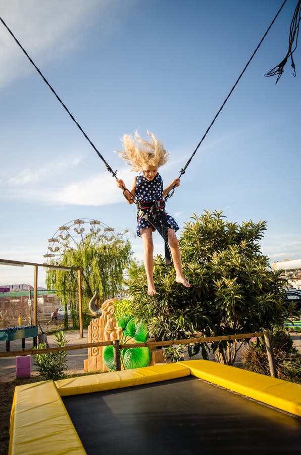 Child on bungee attraction stock photo. Image of long - 60798210