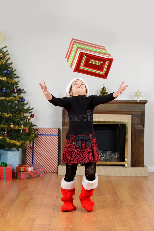 Child Catching Christmas Present Stock Photo - Image of lady ...