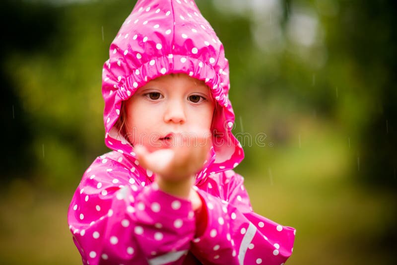 Child catching rain stock image. Image of garden, coat - 60088489