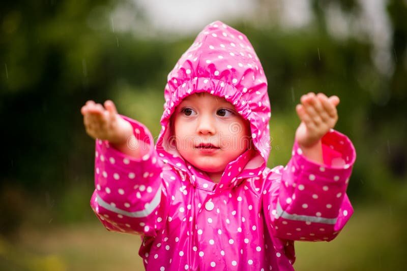 Child catching rain stock image. Image of outside, raincoat - 60088493