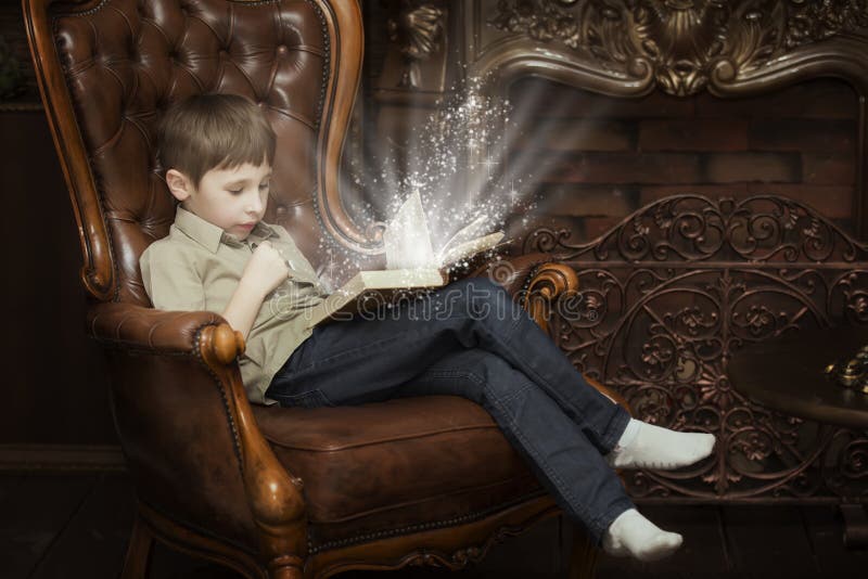 The Child in the Chair Reading a Magic Book. Stock Photo - Image of ...