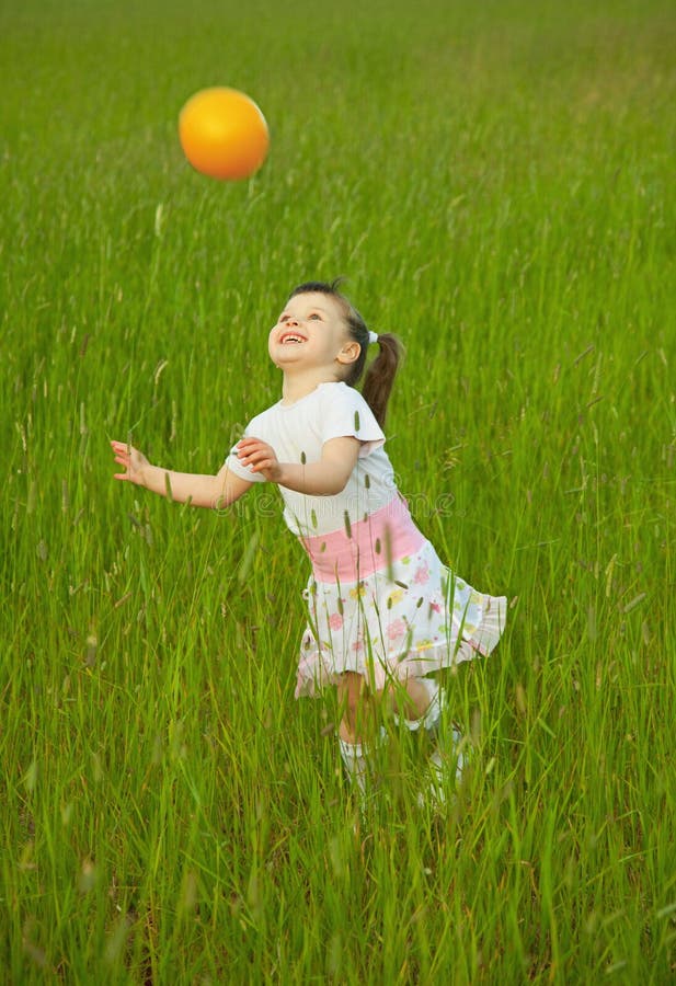 Child Cheerfully Plays with Ball Stock Photo - Image of field, female ...