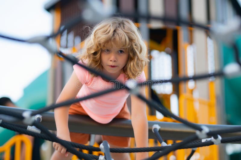 Child Climbing the Net at the Playground. Stock Image - Image of ...