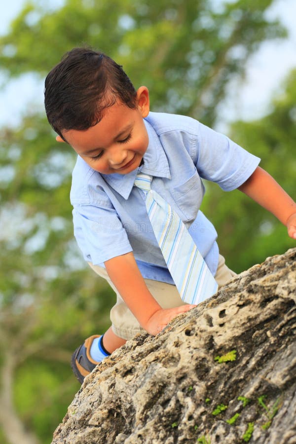 Child Climbing a Rock stock image. Image of nature, looking - 5469747