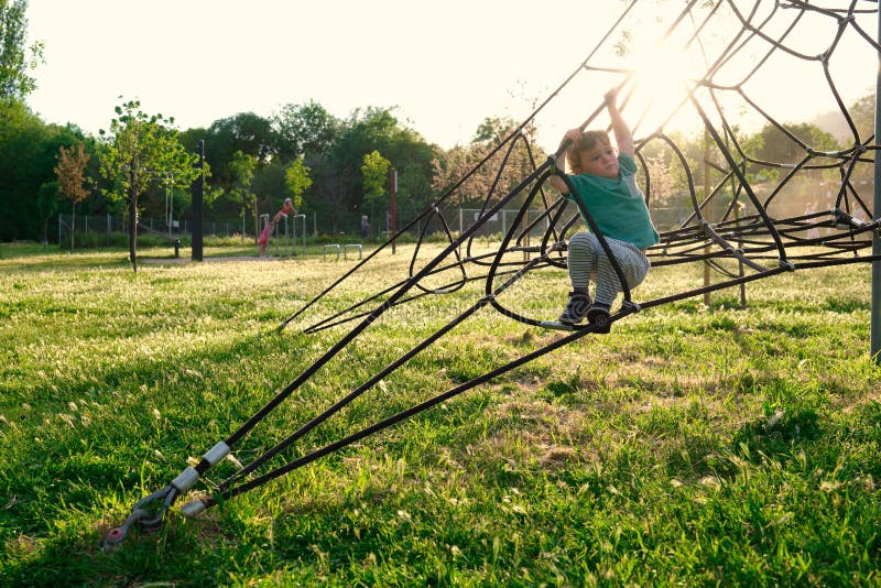 Child Climbing on a Rope-ladder Web in a Playground Stock Image - Image ...