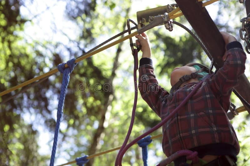Child climbing in rope par stock photo. Image of equipment - 95858536