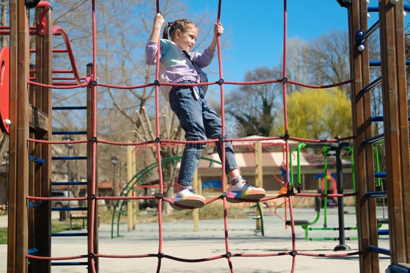 A Child Climbs on a Rope Playground Stock Photo - Image of ...