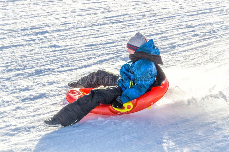 Child Comes Down from the Mountain Riding a Sled Stock Image - Image of ...