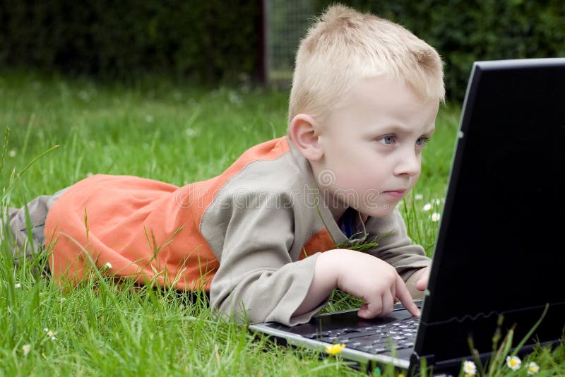 Child and computer stock photo. Image of flower, grass - 5264948