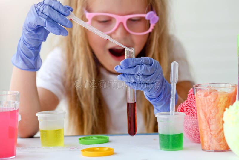 The Child Conducts Experiments. Connects in Test Tubes Fluids of ...